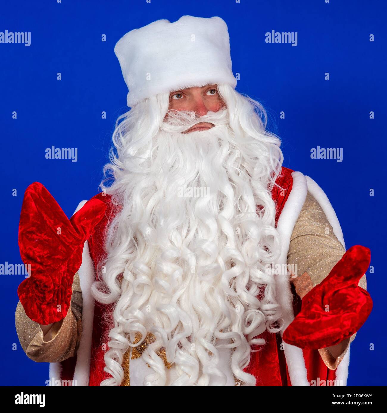 Emotional Santa Claus with a long white beard in a red coat and white ...