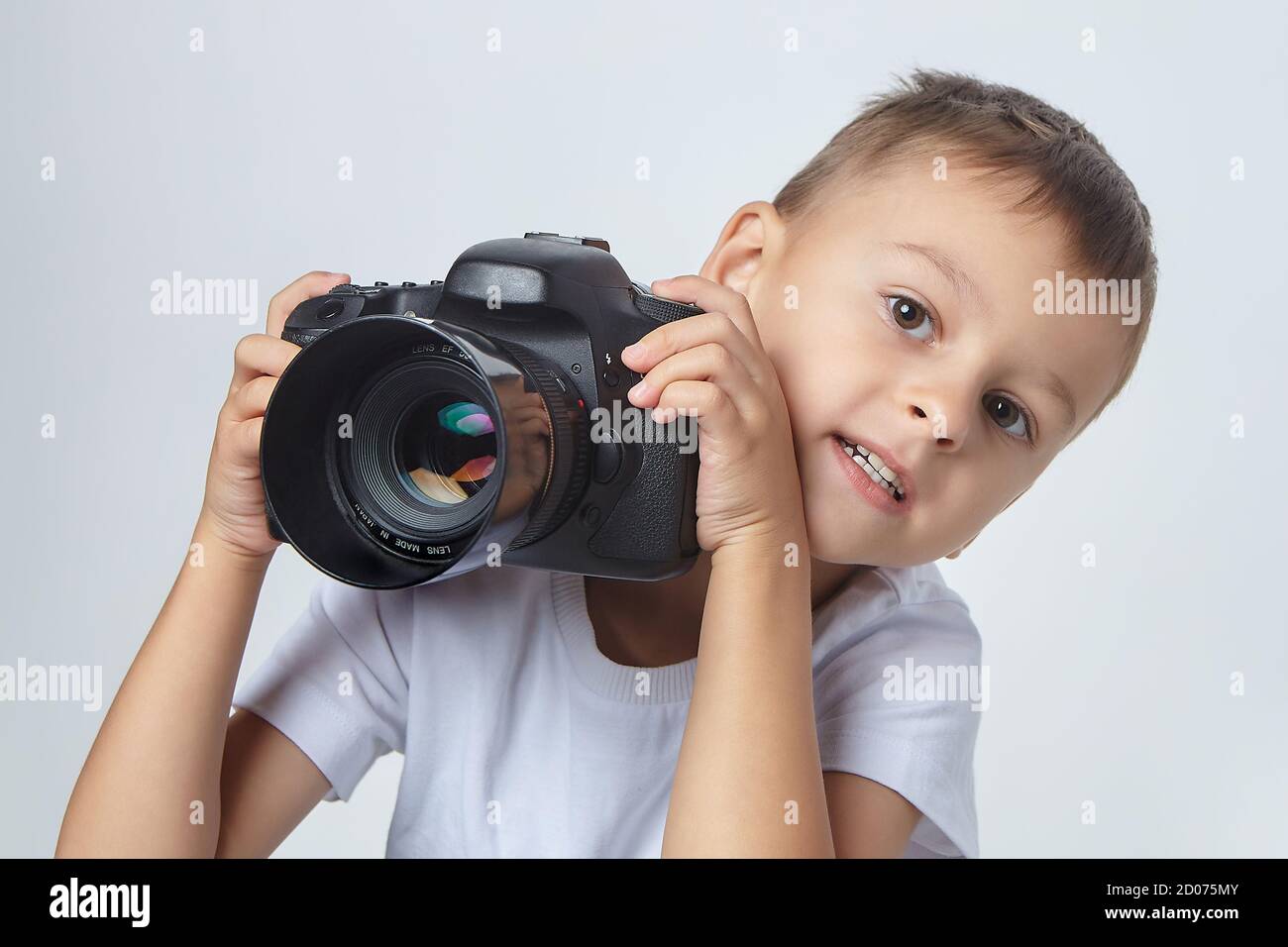 cute boy posing with a camera in a Studio on a white background Stock ...