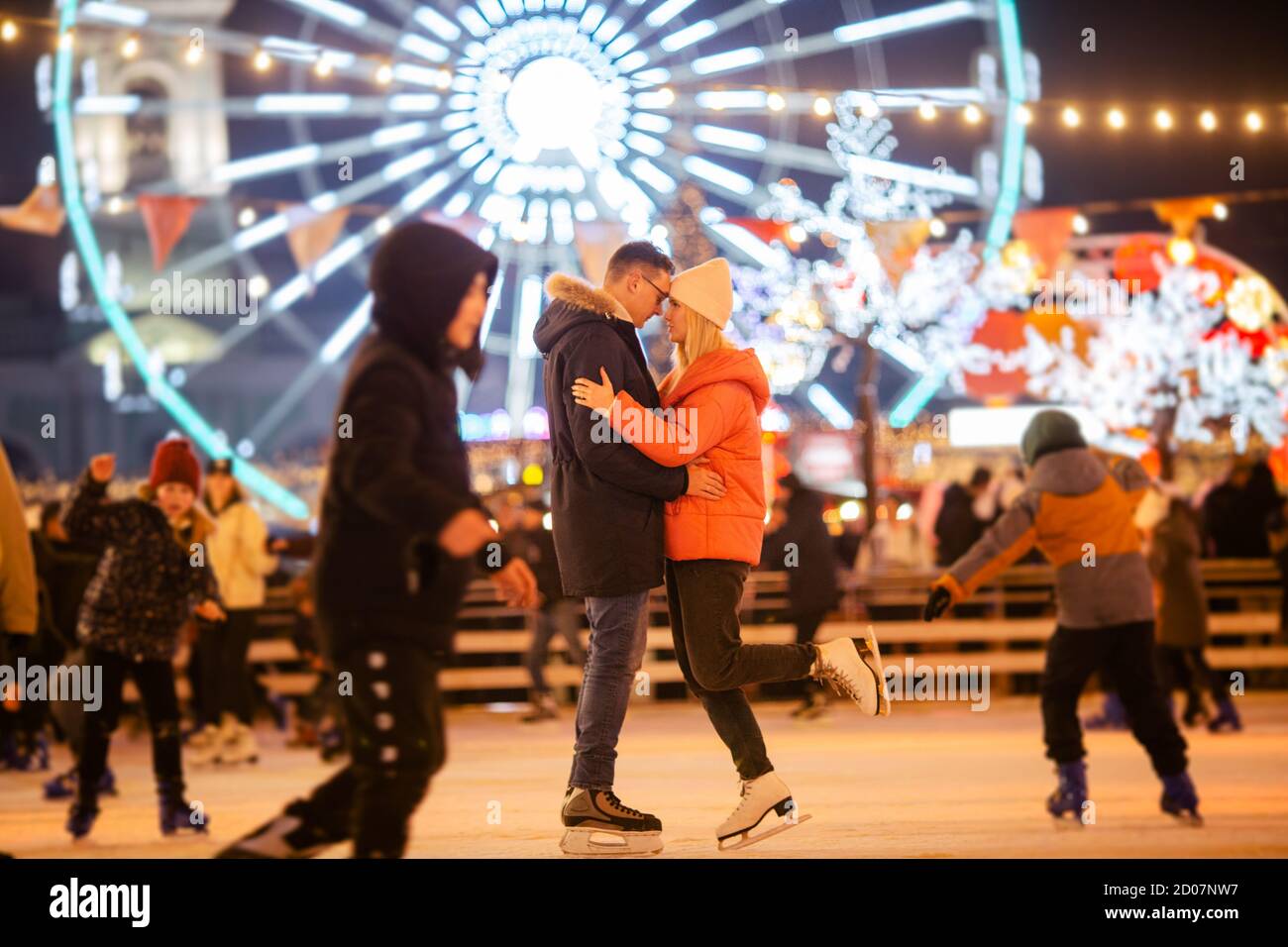 Beautiful Couple Ice Skating In City Centre. Young couple skating at a ...