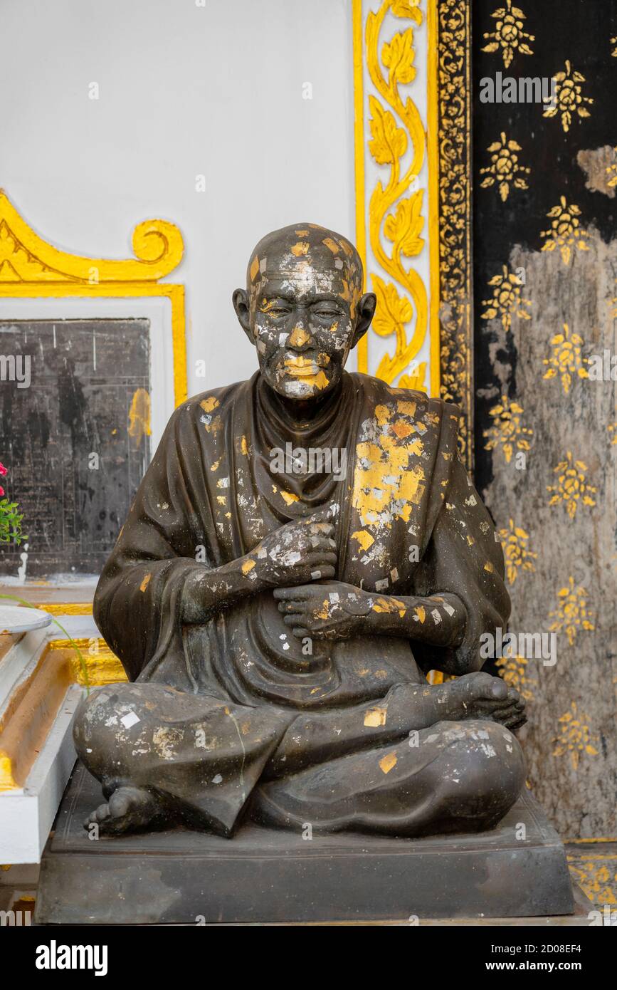 Statue of Sitting Monk Splattered With Paint Stock Photo - Alamy