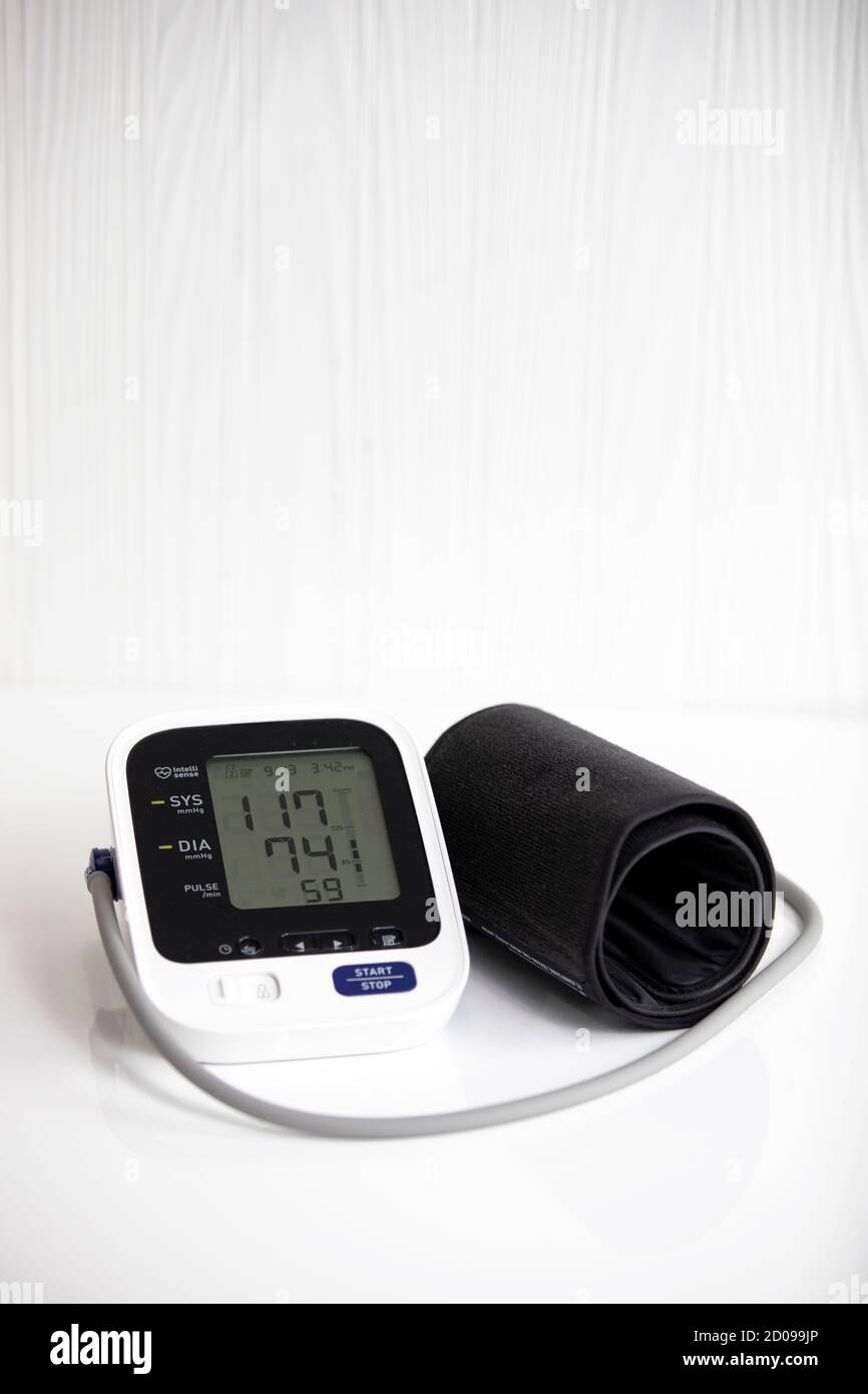 Blood pressure monitor, white background vertical Stock Photo - Alamy