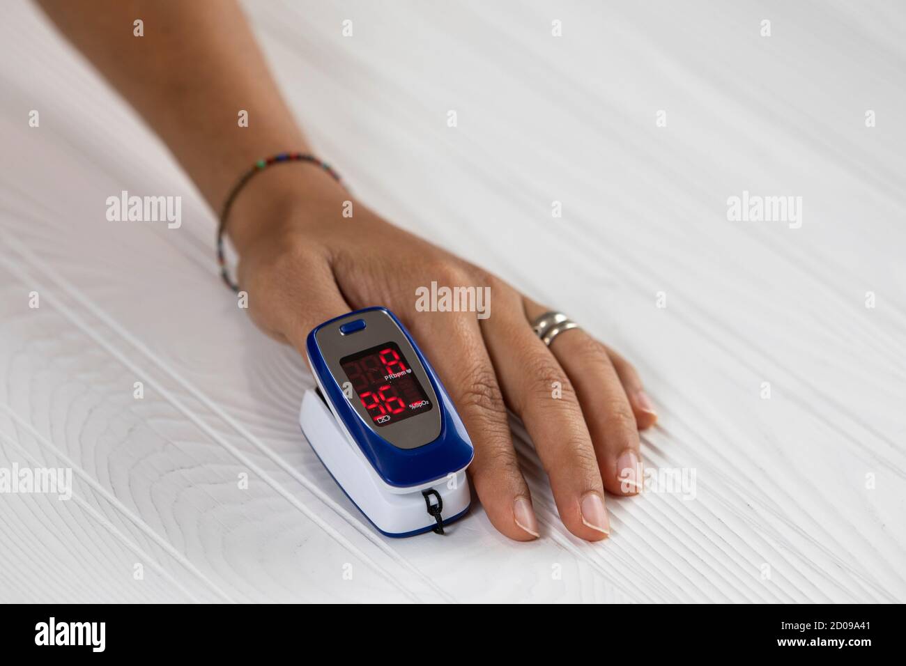 Pulse oximeter on a woman finger used to test blood oxygen level in ...