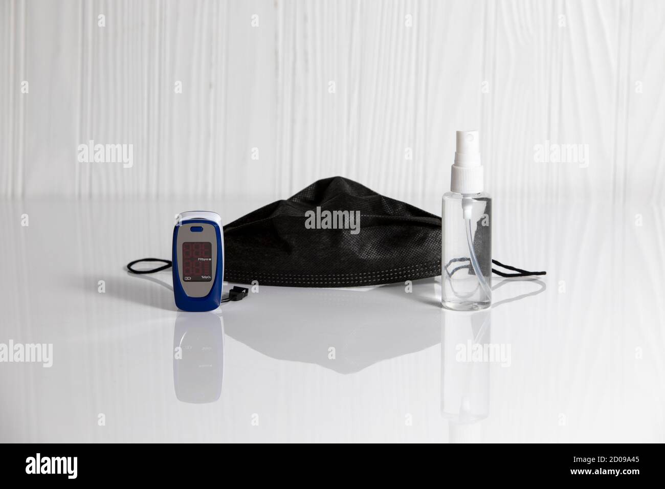 face-mask oximeter and disinfect liquid over a white background Stock ...