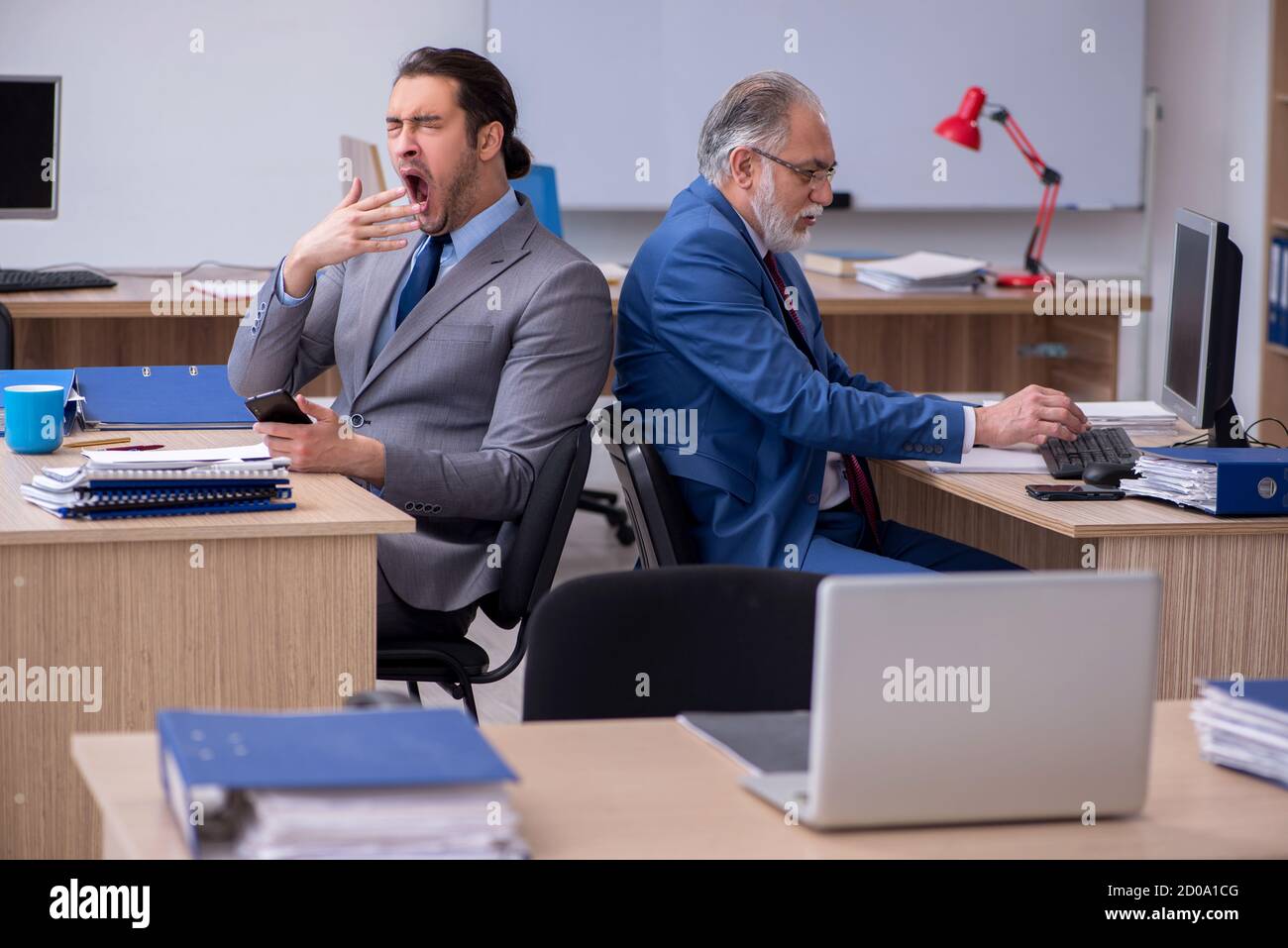 Two employees working in the office Stock Photo - Alamy