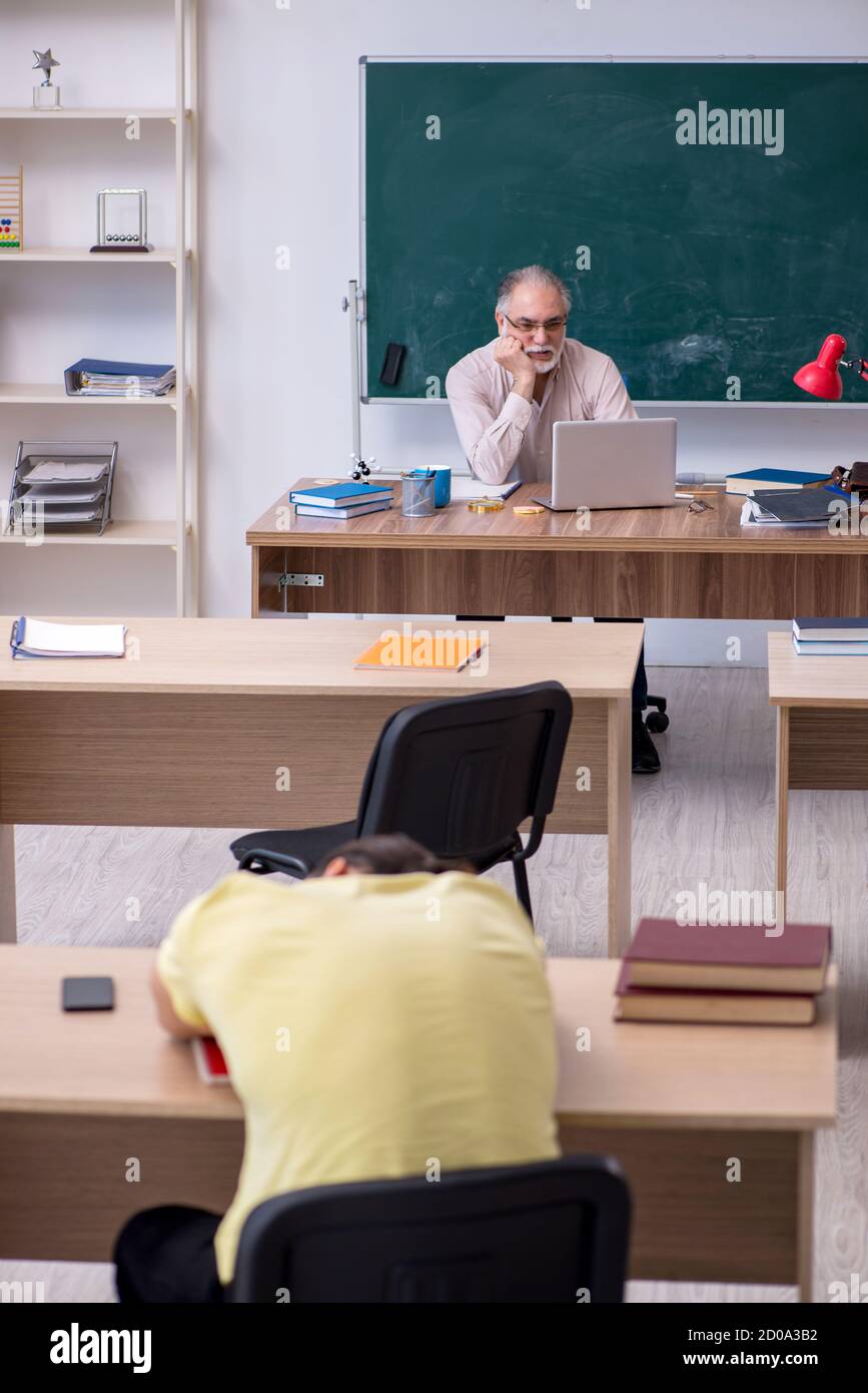 Old teacher and young student in the classroom Stock Photo - Alamy