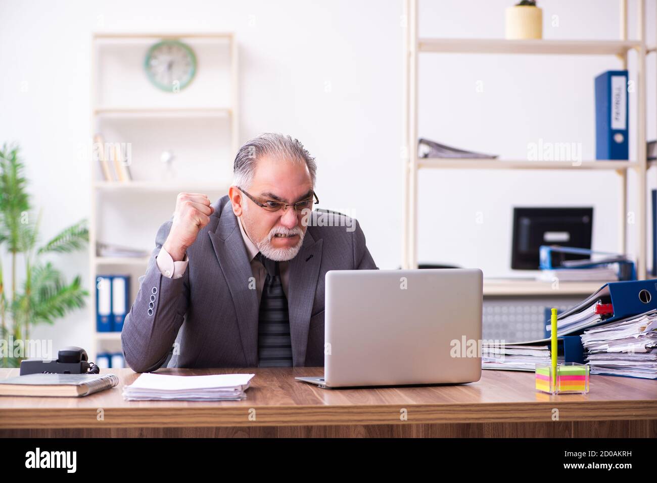 Businessman angry and furious at his workplace Stock Photo - Alamy