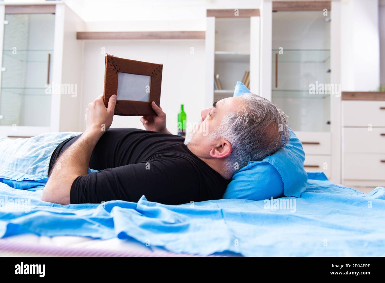 Old man in depression mode at home Stock Photo - Alamy
