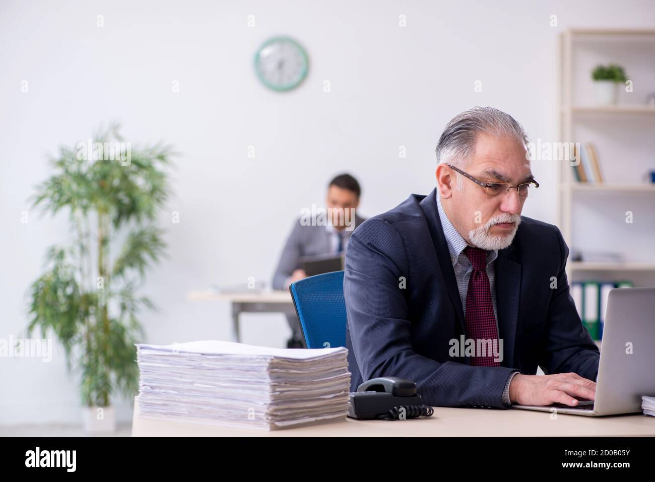 Old boss and his assistant working in the office Stock Photo - Alamy