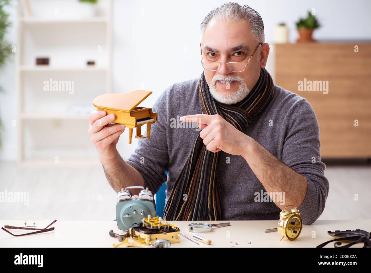 Old watchmaker working in the workshop Stock Photo - Alamy