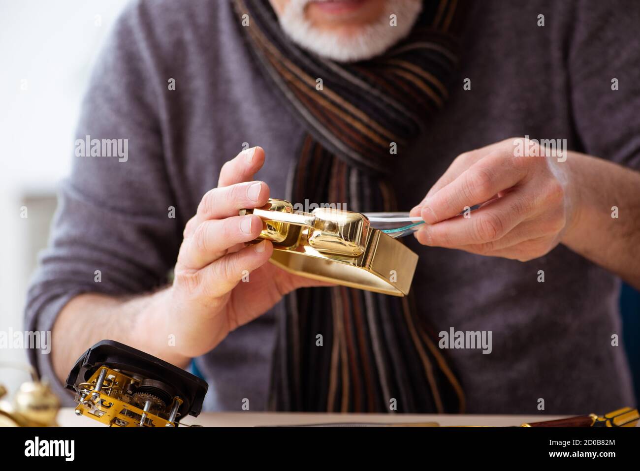Old watchmaker working in the workshop Stock Photo - Alamy