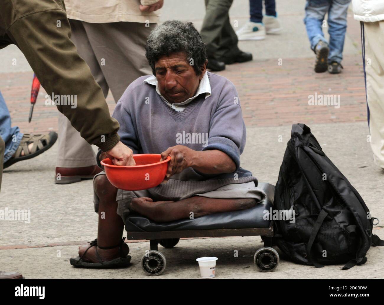 Beggar receives hi-res stock photography and images - Alamy