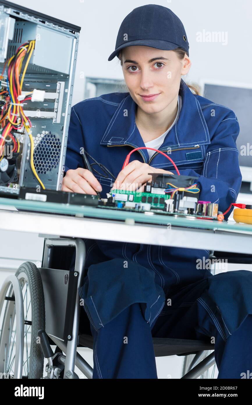 young female in wheelchair fixing a pc Stock Photo - Alamy