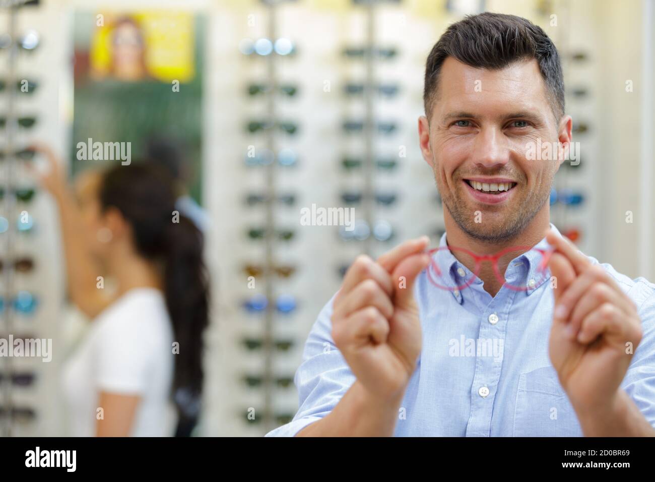 a handsome man choosing spectacles Stock Photo - Alamy