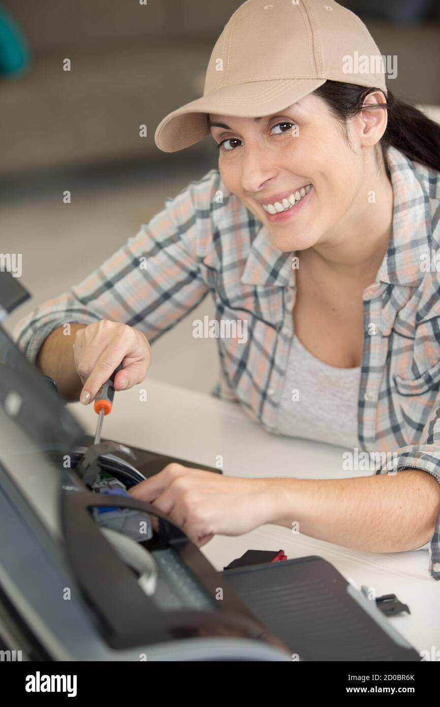 happy woman fixing a printer Stock Photo - Alamy