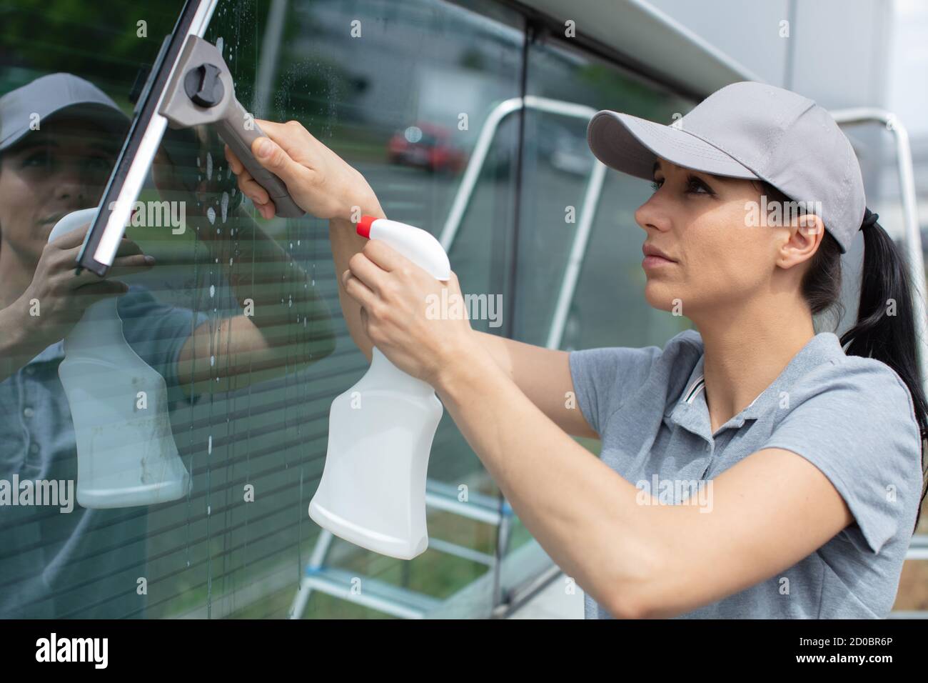 beautiful woman cleaning a window outdoors Stock Photo - Alamy
