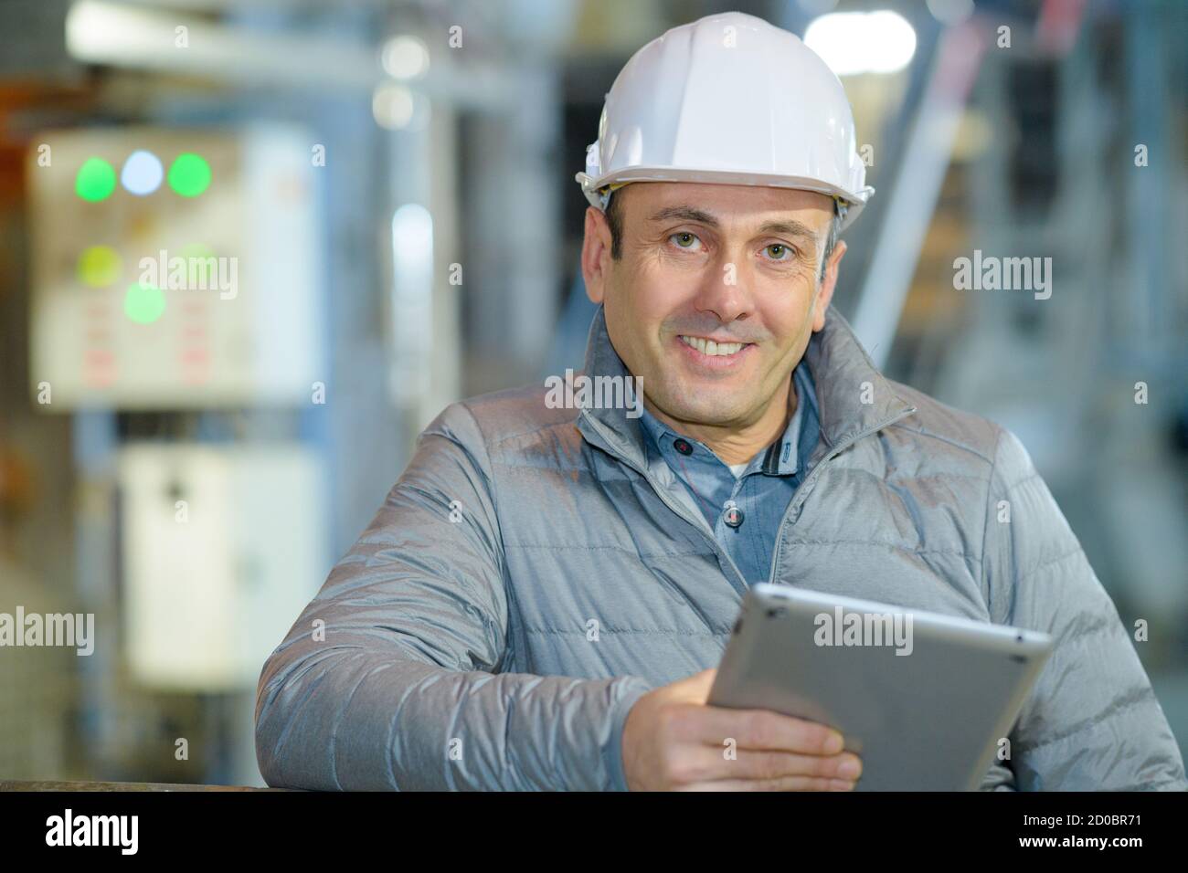 engineer with tablet working in factory Stock Photo - Alamy