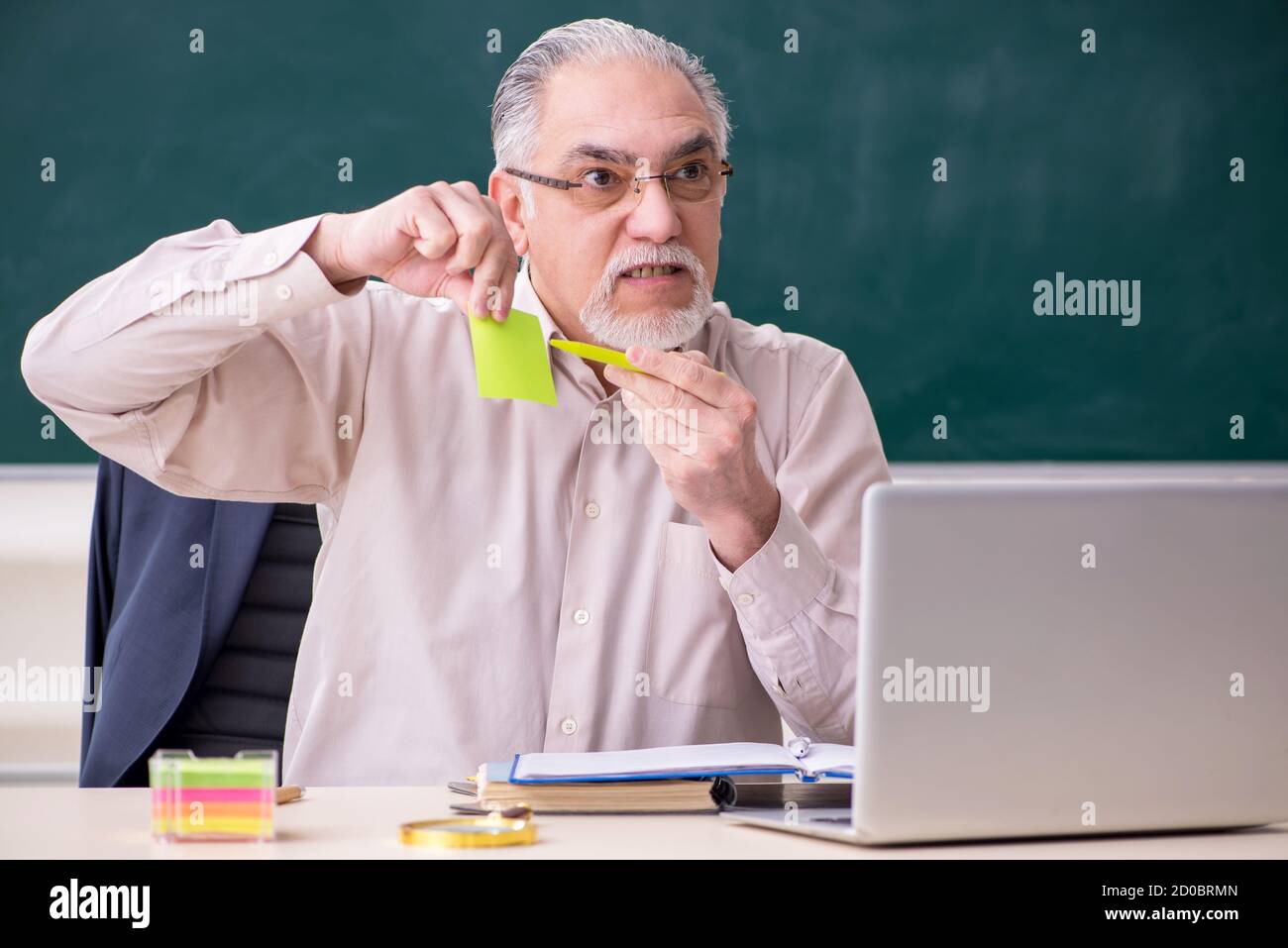 Old male teacher in the classroom of college Stock Photo - Alamy