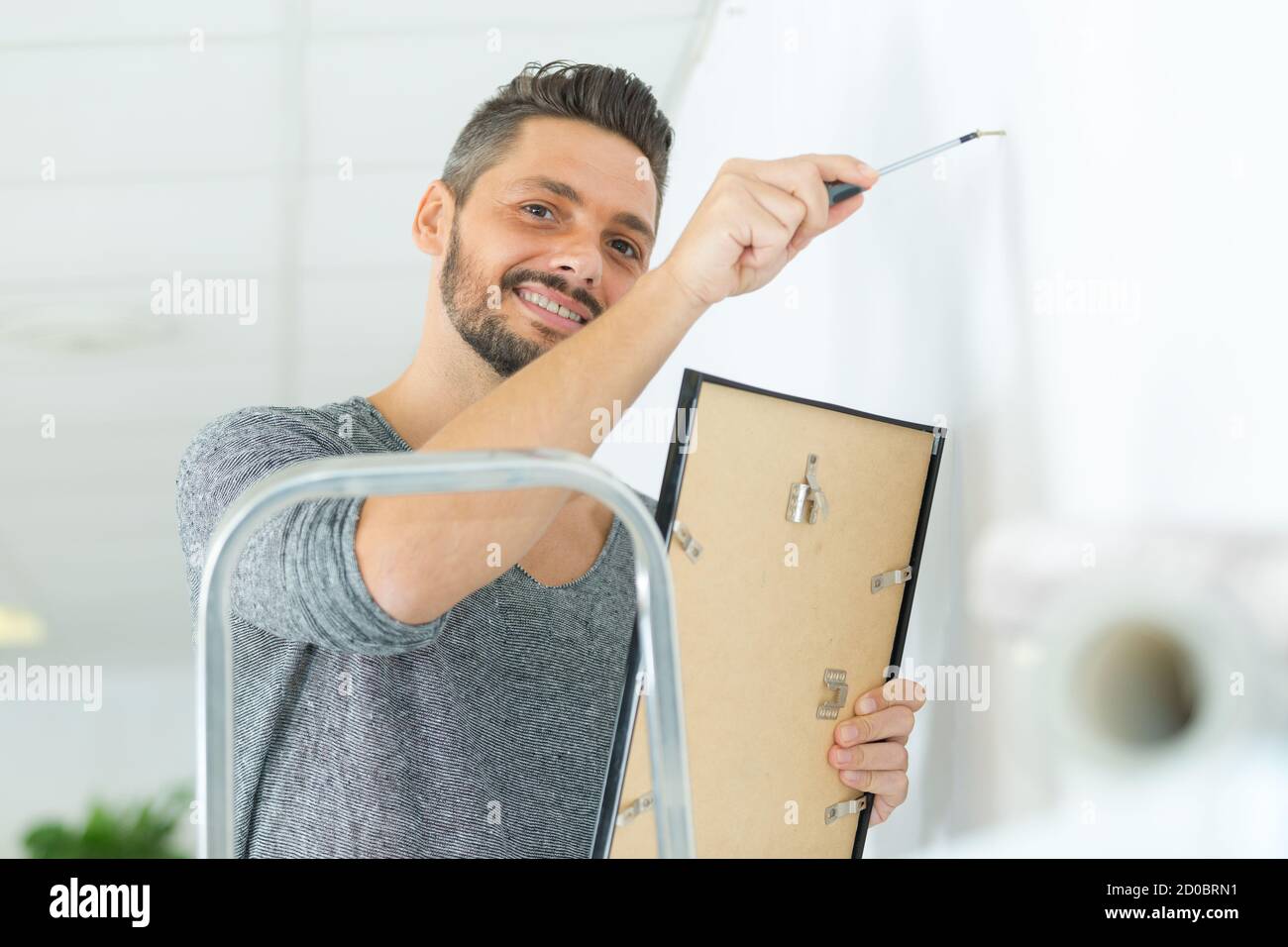 Putting up picture hi-res stock photography and images - Alamy