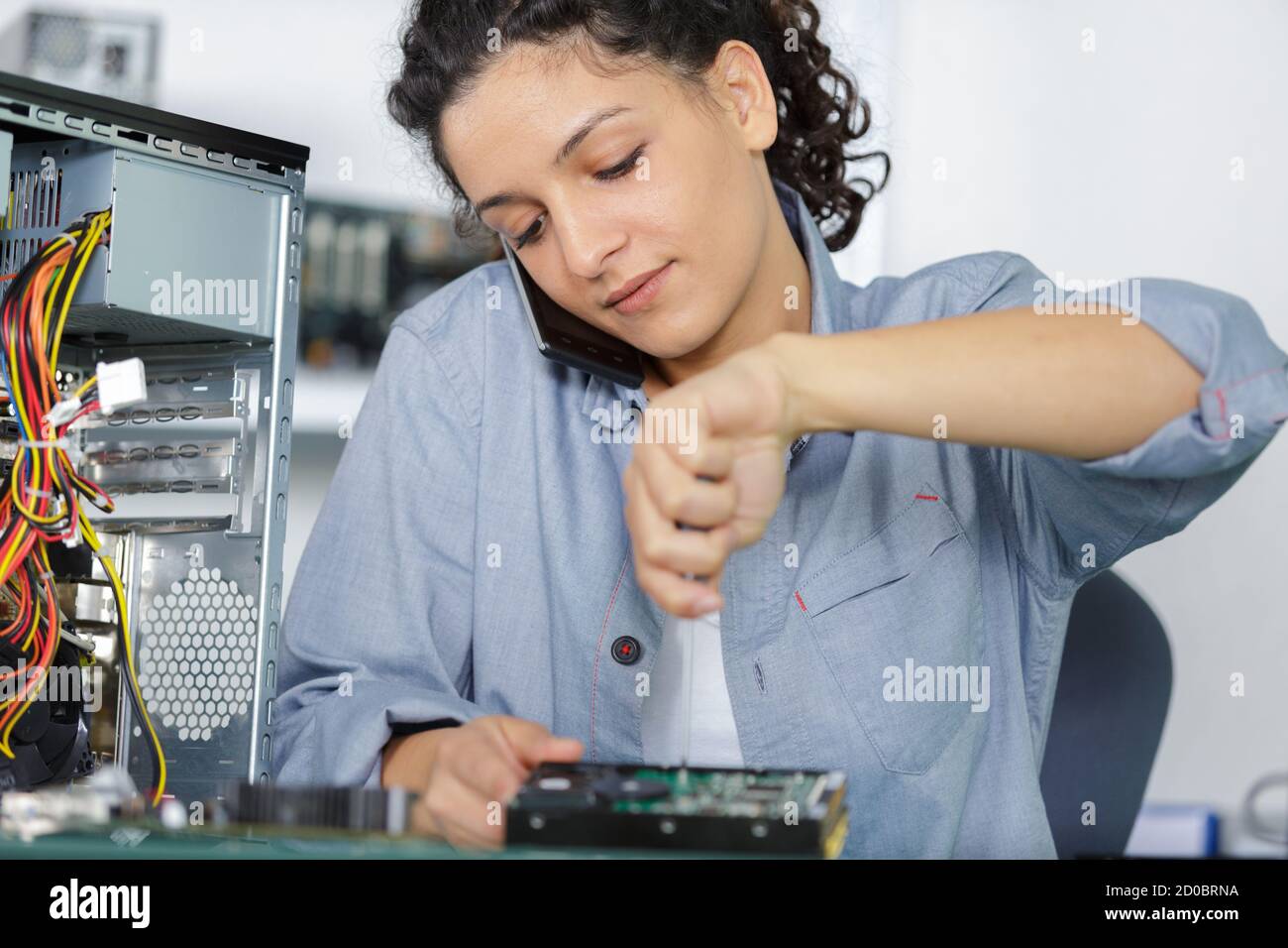 female pc technician working on desktop computer Stock Photo - Alamy