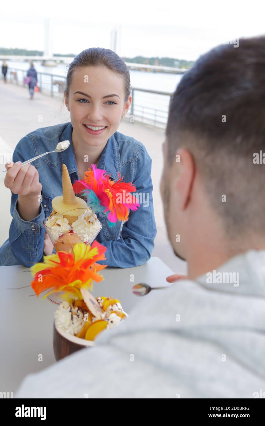 young couple eating ice-cream sundaes in cafe Stock Photo - Alamy