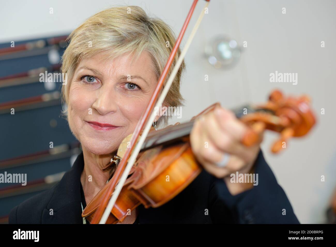 Portrait of mature lady playing violin Stock Photo - Alamy
