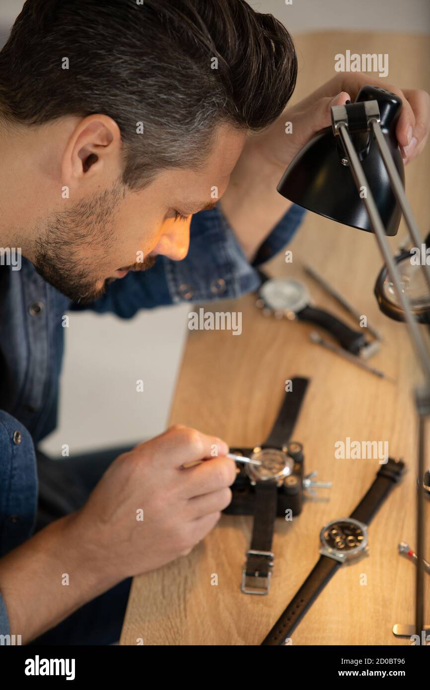 a watchmaker is fixing a watch Stock Photo - Alamy