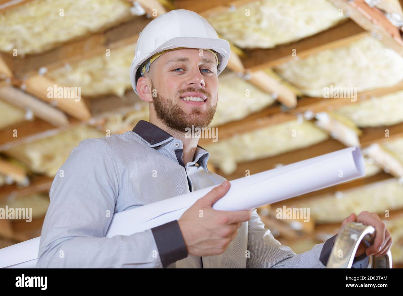 an engineer man holding blueprints Stock Photo - Alamy