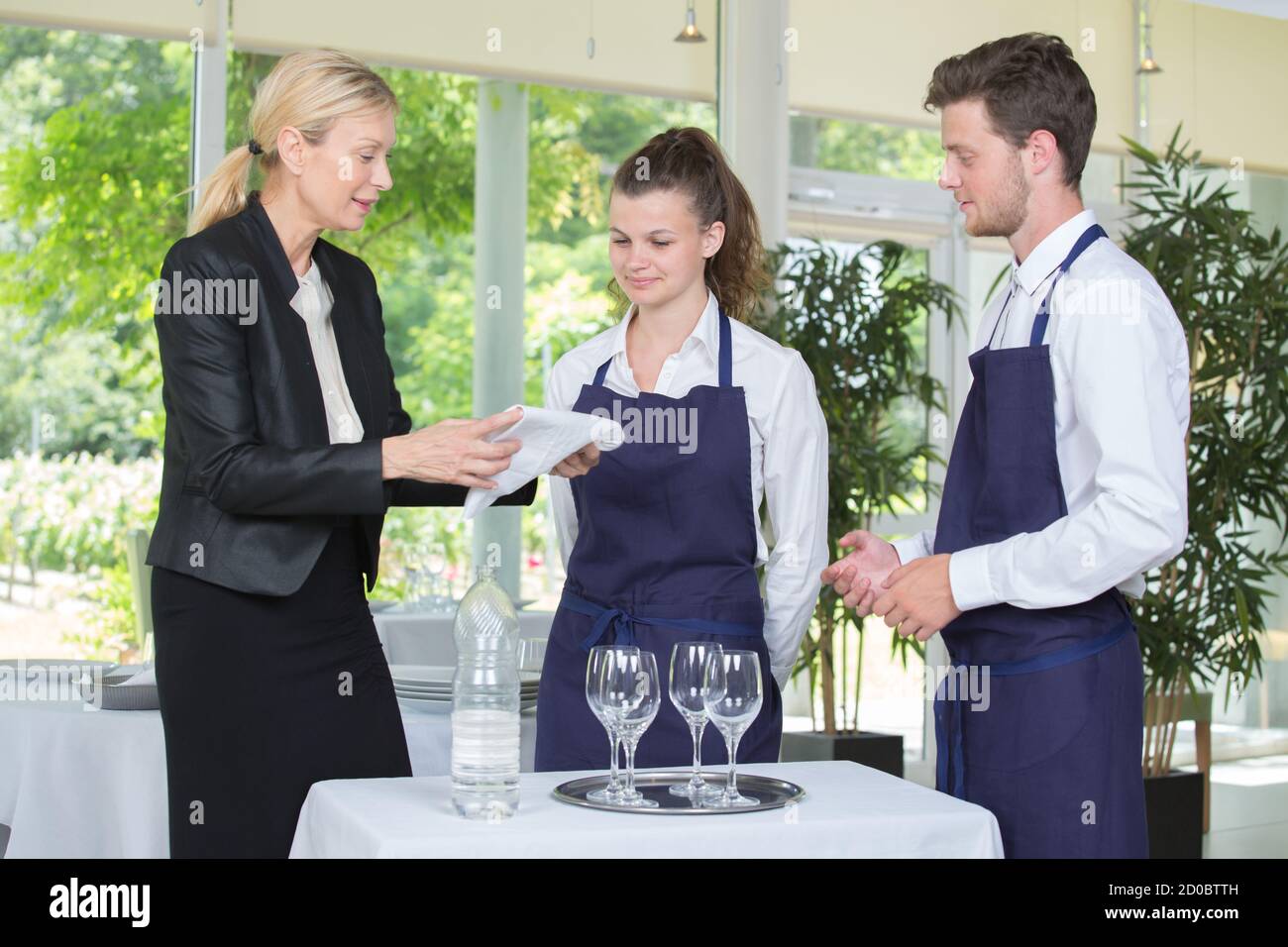 young waiter and waitress at service in restaurant Stock Photo - Alamy