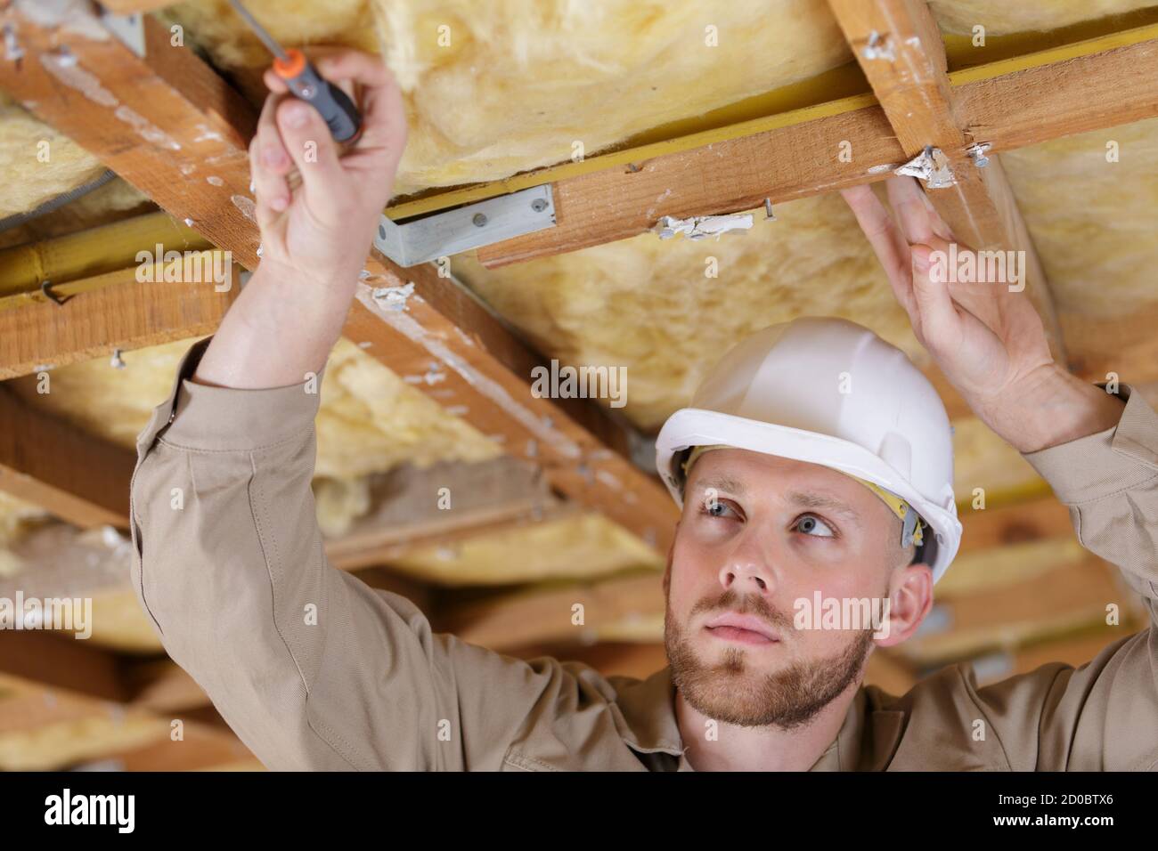 man pulling to the ceiling in repair loft apartment Stock Photo - Alamy