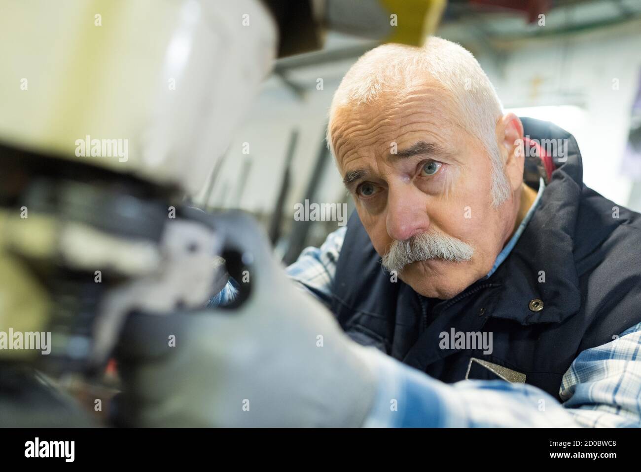 aged man working in an industrial factory Stock Photo - Alamy