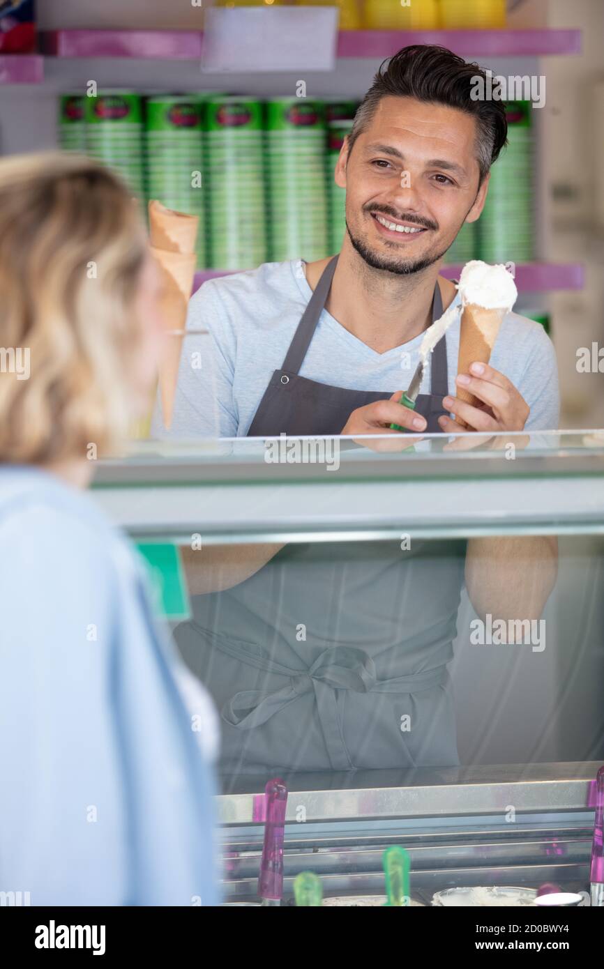 ice cream seller giving ice cream to a customer Stock Photo - Alamy