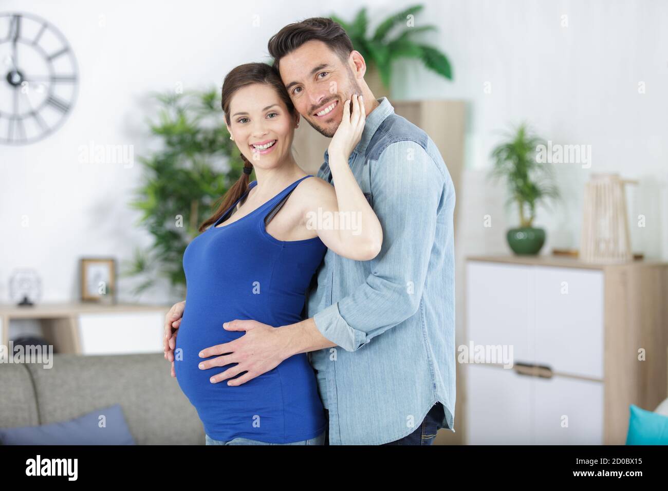 happy pregnant couple hugging at home Stock Photo - Alamy