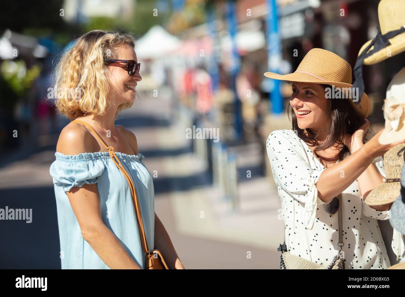 two friends girls have fun while shopping outdoor flea market Stock ...