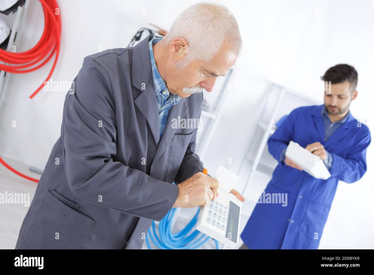 senior and junior technicians at work Stock Photo - Alamy