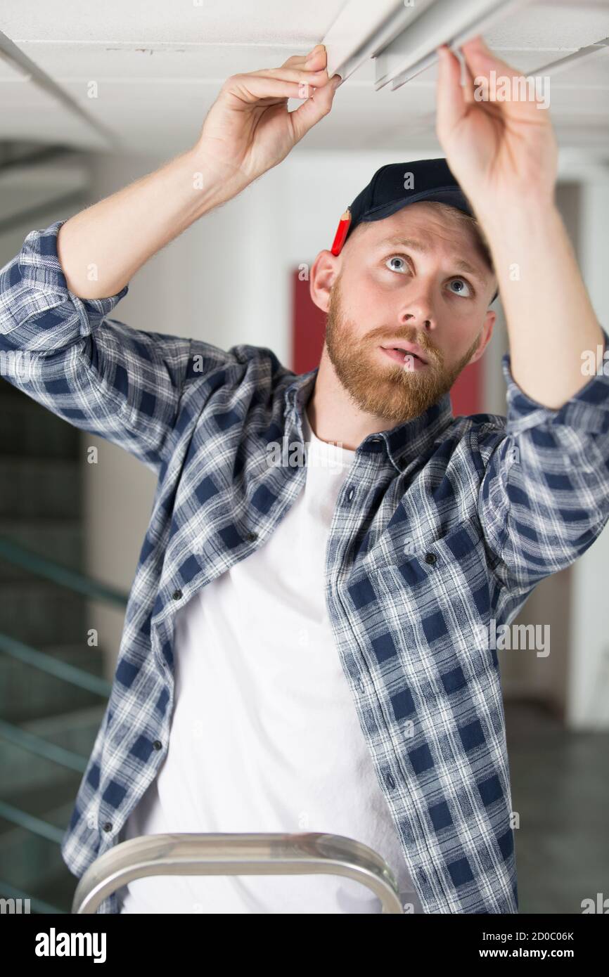 fixing of ceiling light with screwdriver Stock Photo - Alamy