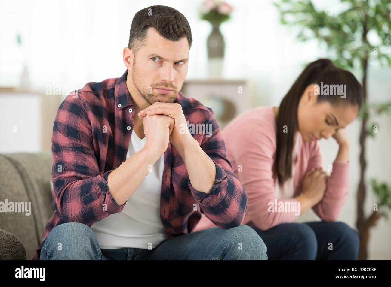 couple on the sofa ignoring each other after an argument Stock Photo ...