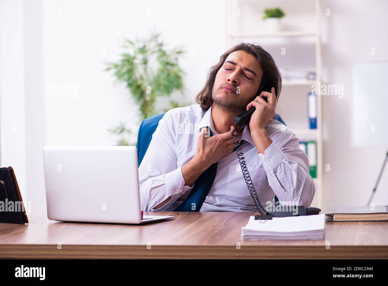 Drug addicted employee working in the office Stock Photo - Alamy