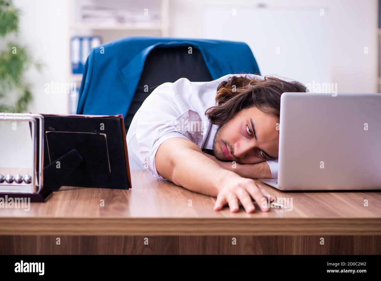 Drug addicted employee working in the office Stock Photo - Alamy