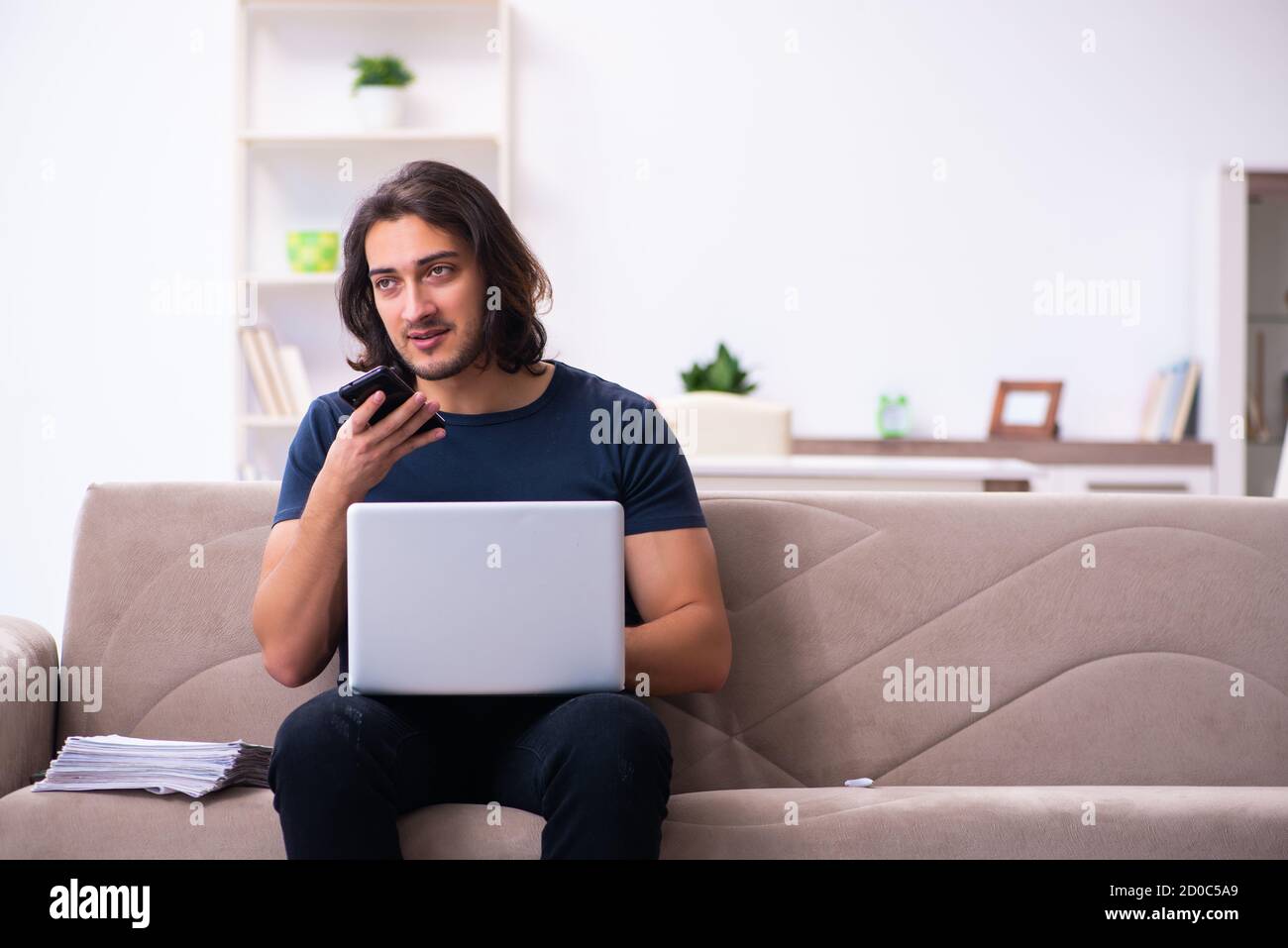 Young man employee working from home Stock Photo - Alamy