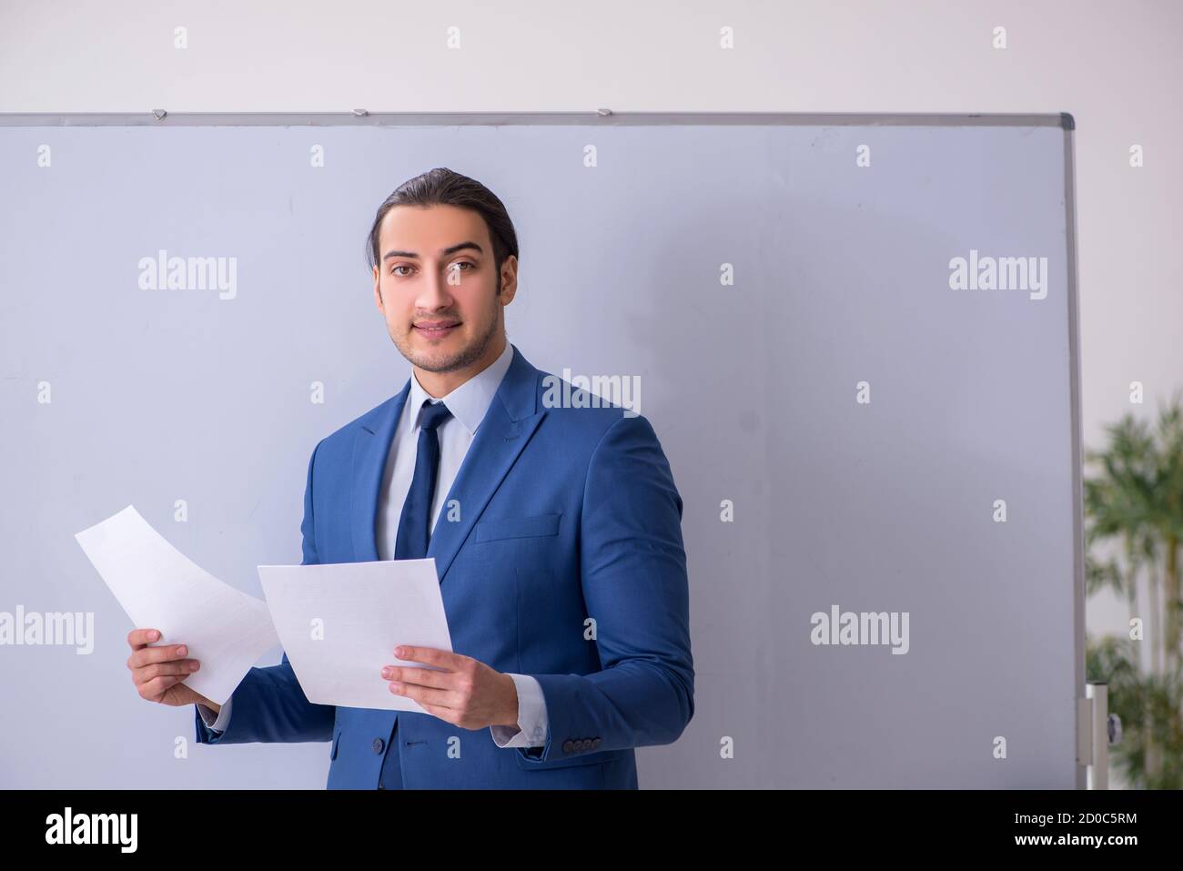 Young man employee presenting in the office Stock Photo - Alamy