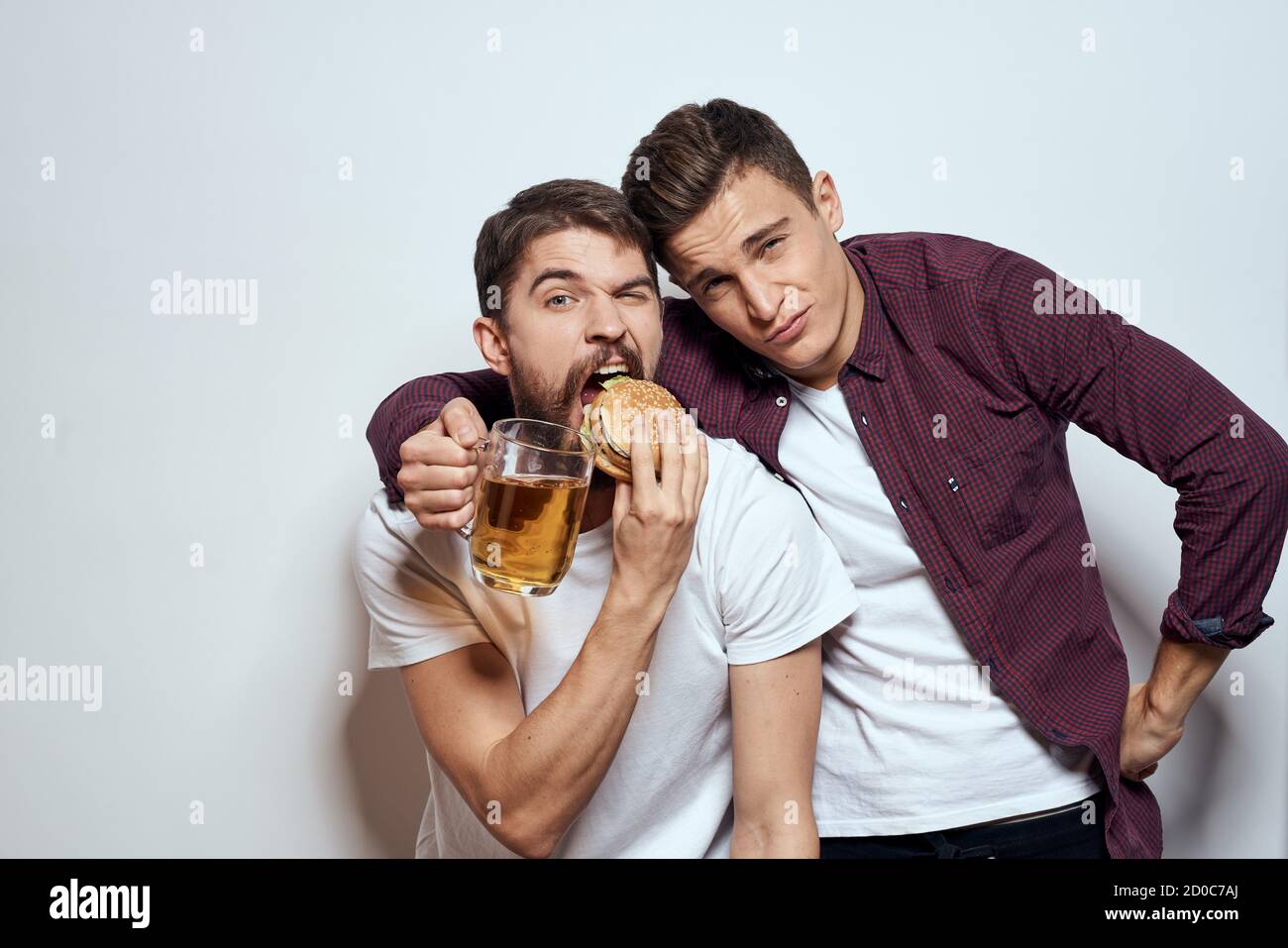 Two cheerful friends drinking beer drunk fun lifestyle communication ...