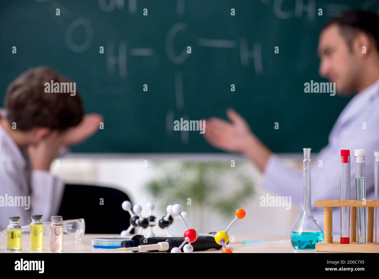 Young chemistry teacher and schoolboy in classroom Stock Photo - Alamy