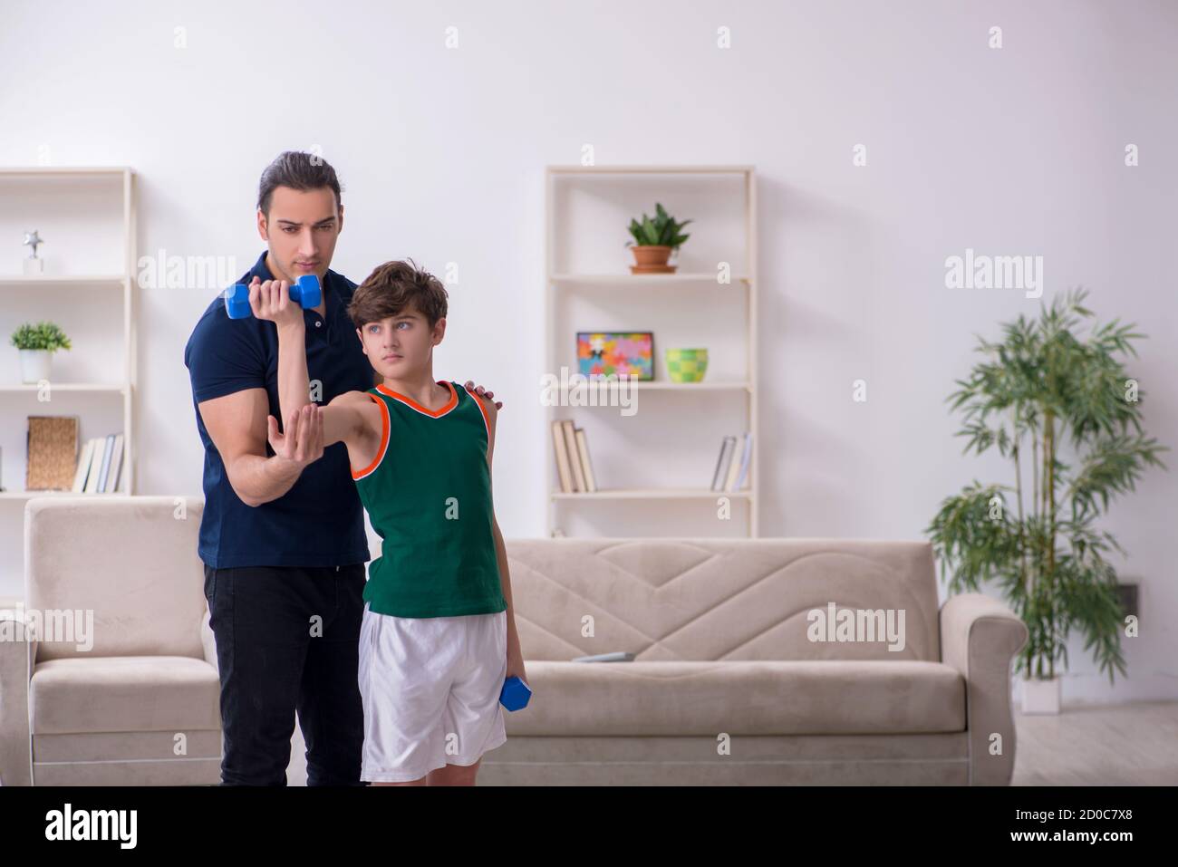 Father and son doing sport exercises at home Stock Photo - Alamy