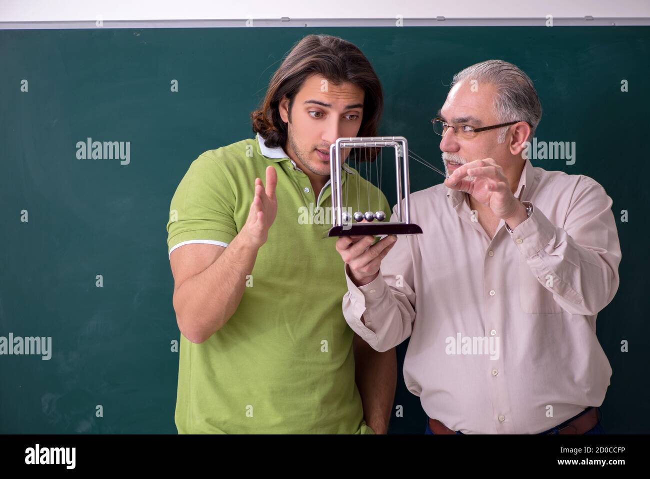 Old professor physicist and student in the classroom Stock Photo - Alamy
