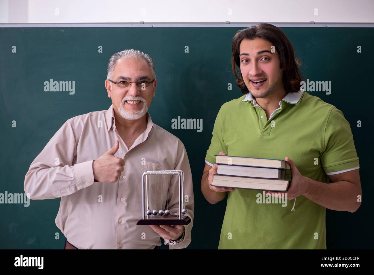 Old professor physicist and student in the classroom Stock Photo - Alamy