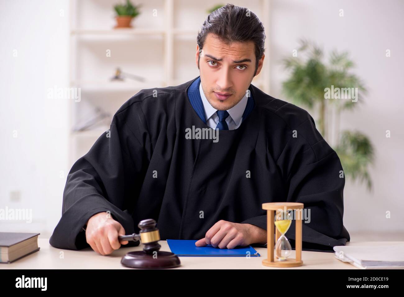 Young judge in time management concept Stock Photo - Alamy