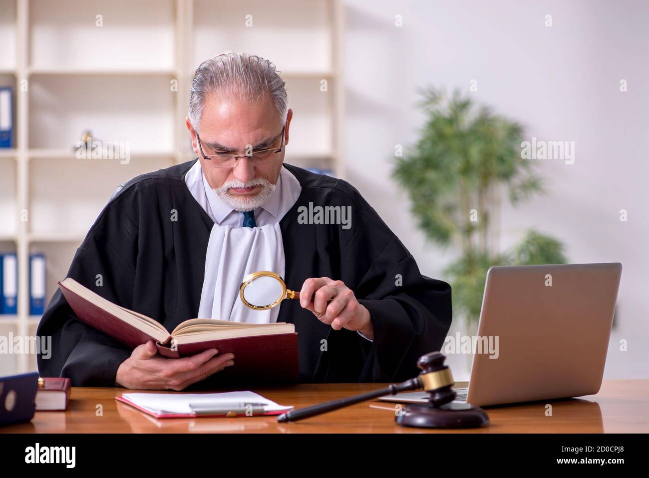 Old male judge working in the courthouse Stock Photo - Alamy