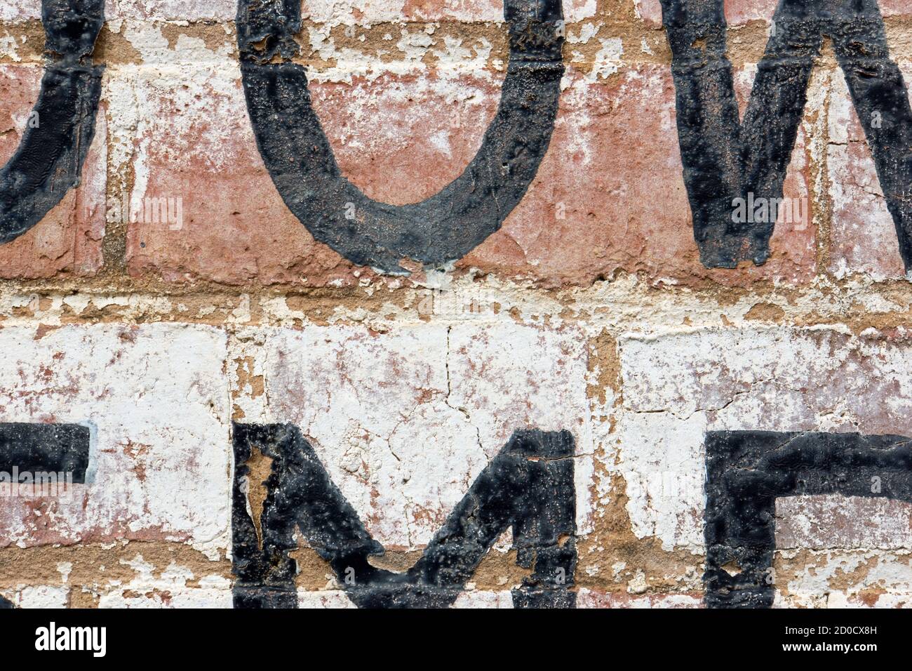 Vintage brick wall texture with black graphic lettering and abstract ...