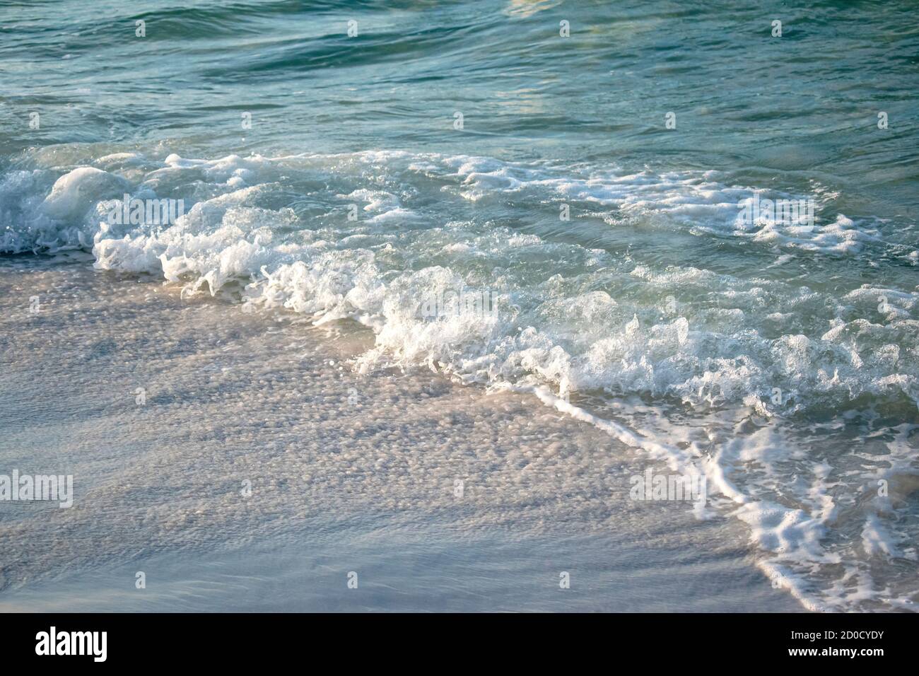 Tide coming in on the beach Stock Photo - Alamy