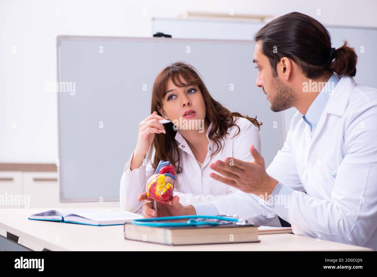 Male doctor showing female trainee hi-res stock photography and images ...